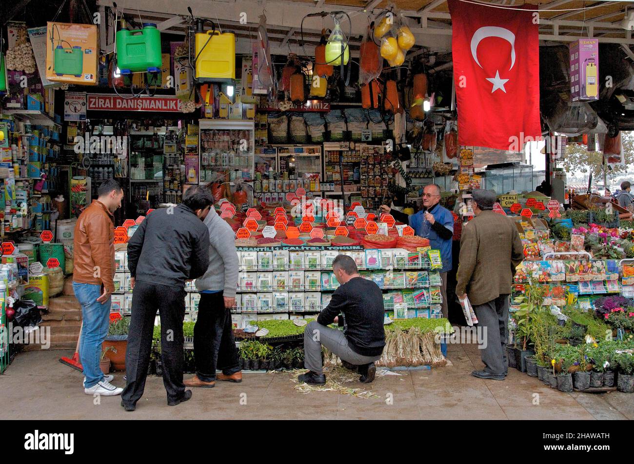 Men in front of plants and spice shop with Turkish flag in Eminoenue ...