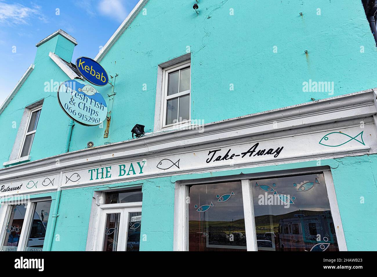 Turquoise blue facade, snack bar, take away, signs saying Kebab, Fish ...