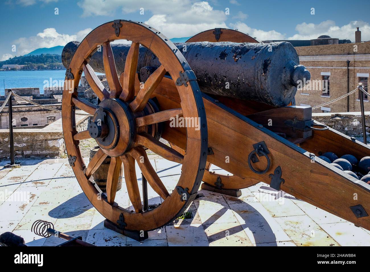 Rusty old iron cannon under the cloudy blue sky Stock Photo - Alamy