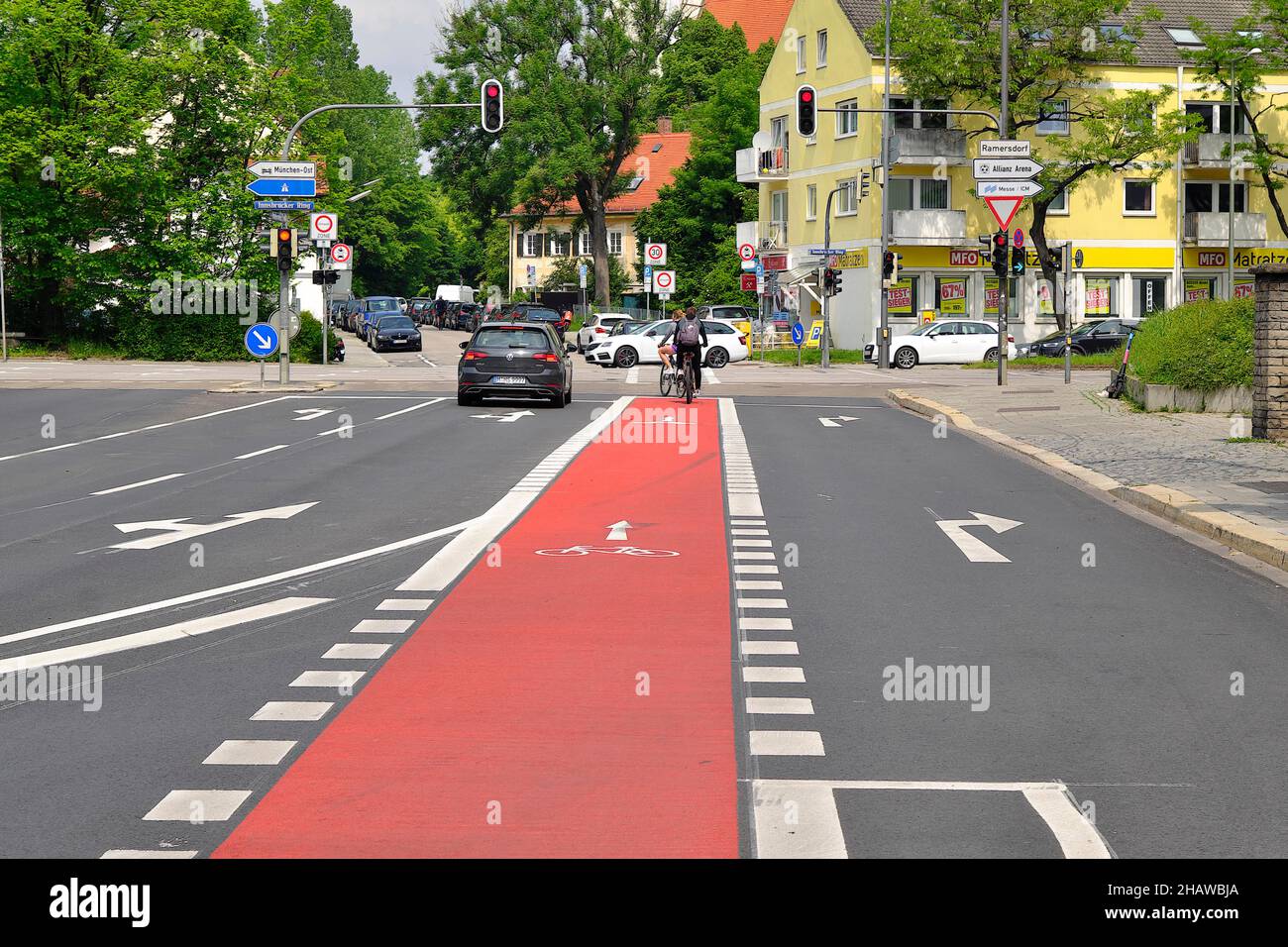Red cycle path between the car lanes, Munich, Bavaria, Germany Stock ...