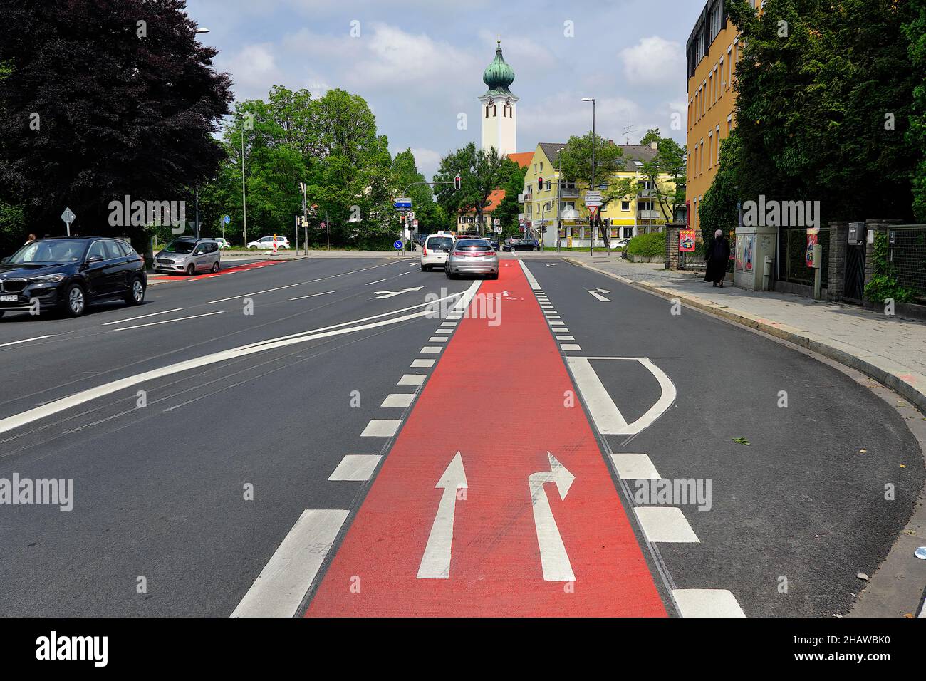 Red cycle path between the car lanes, Munich, Bavaria, Germany Stock ...