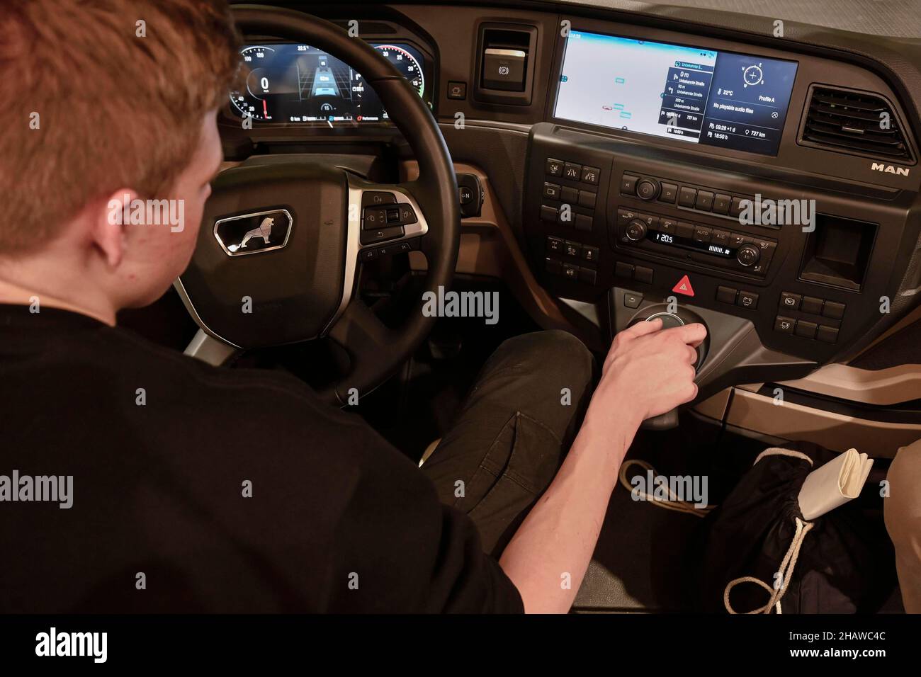 Man operates navigation device MAN electric truck Stock Photo - Alamy