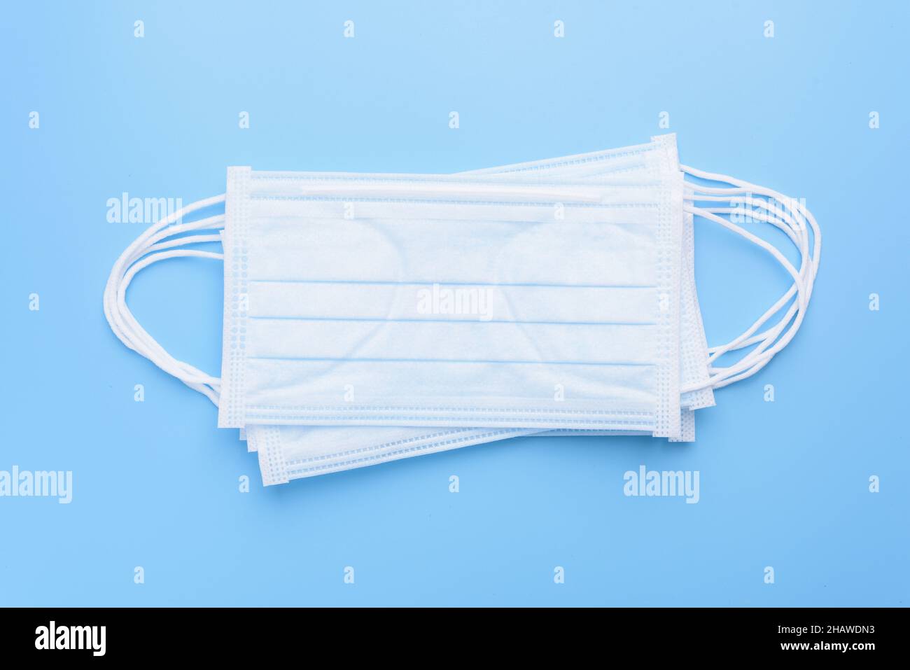 Surgical masks pack on soft blue background,flat lay Stock Photo - Alamy