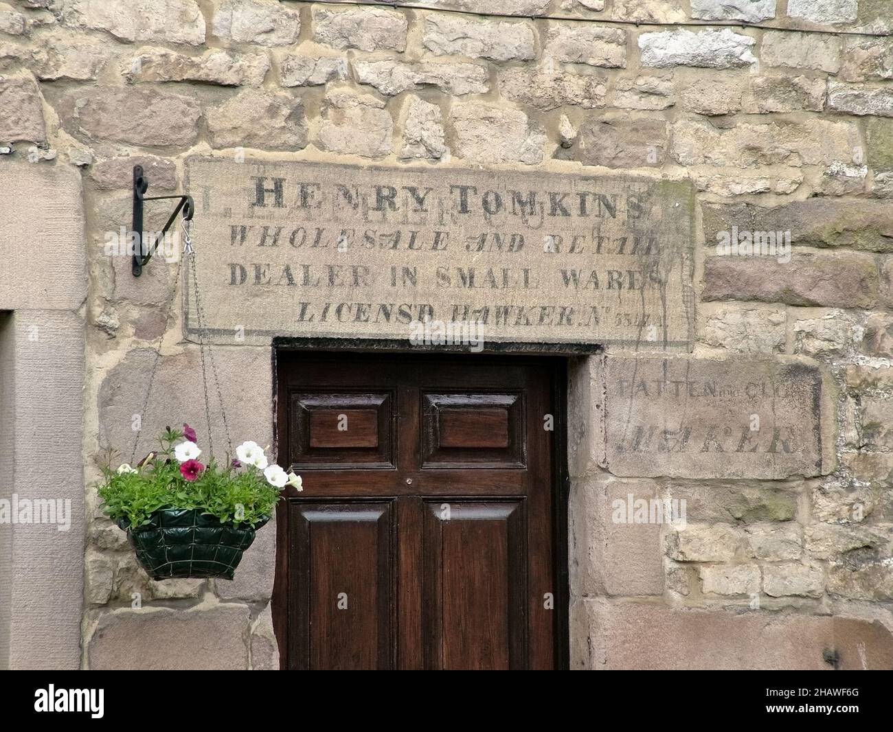 Ghost sign above house doorway. Winster village Derbyshire England ...