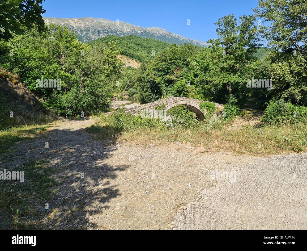 Greece, ancient stone bridge Kamber Aga aka Kamper Aga with reflection ...