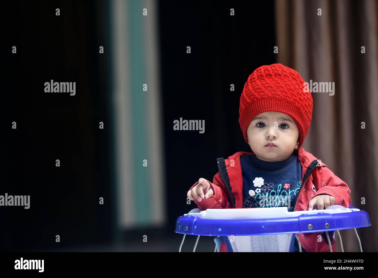 First steps of an adorable Indian girl in a baby walker Stock Photo - Alamy