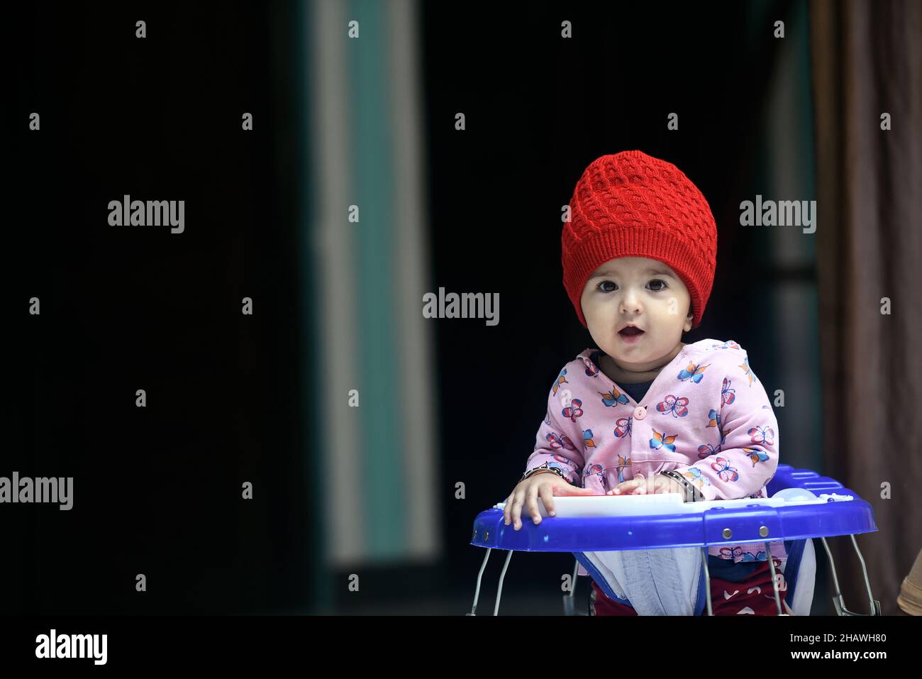 First steps of an adorable Indian girl in a baby walker Stock Photo - Alamy