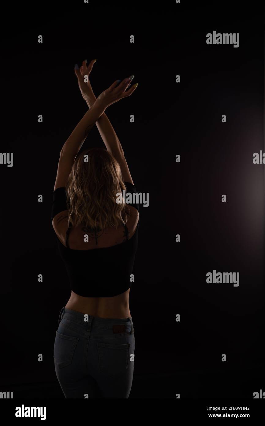 beautiful slender woman dancing to music in the dark Stock Photo - Alamy