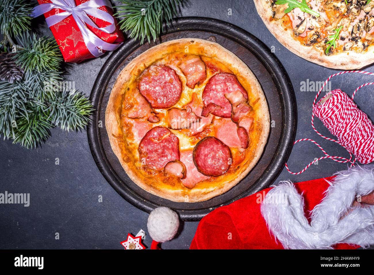 Christmas decorated background with pepperoni and mushrooms pizza ...