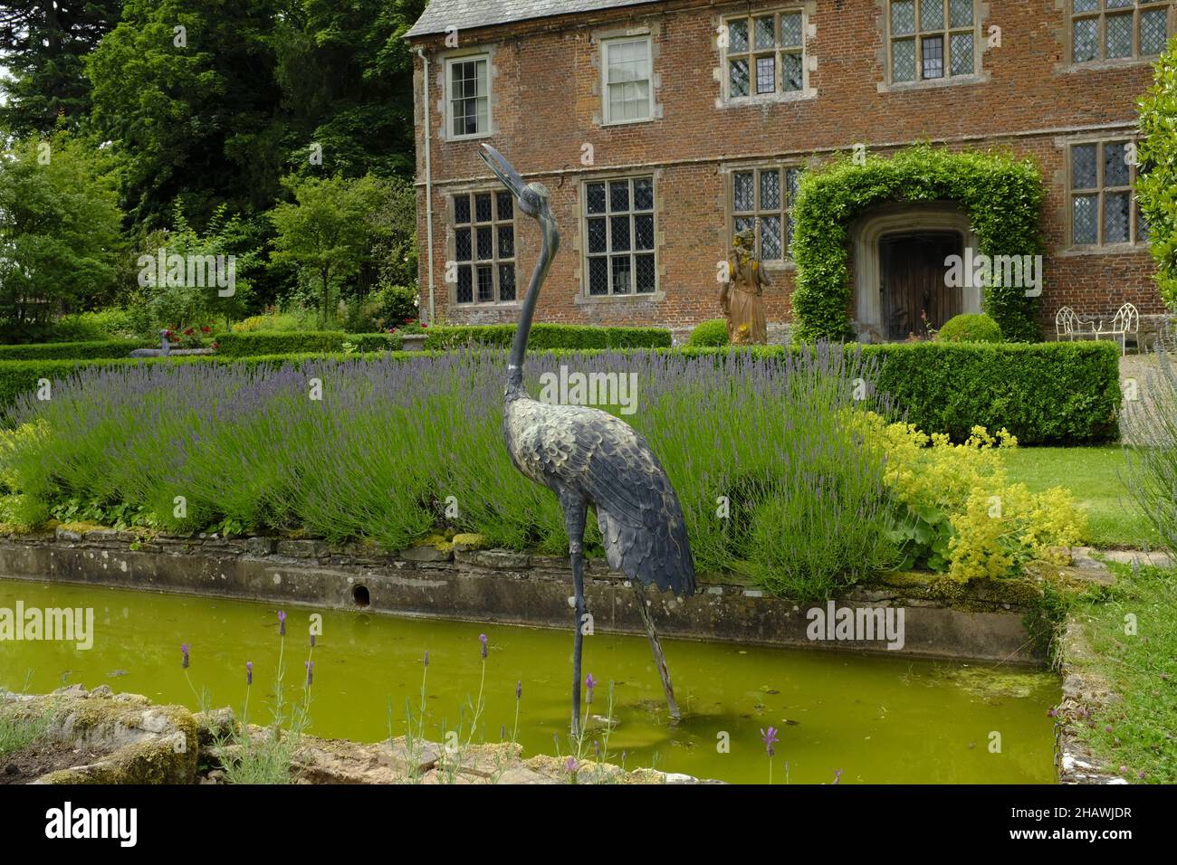 Sculpture of a bird in the gardens in front of historic Hellens House ...