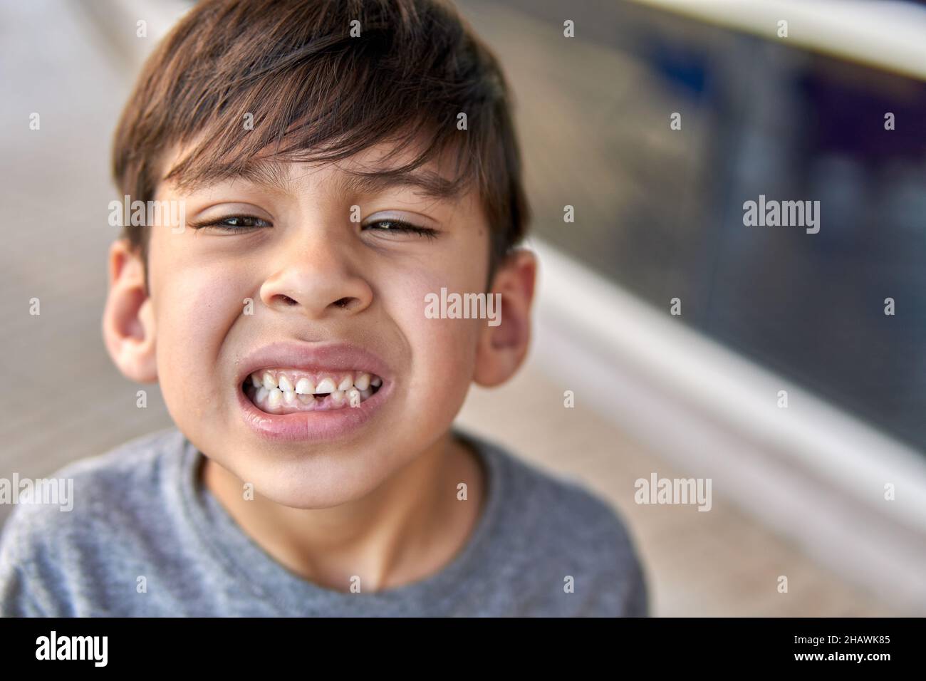 latino toddler drops his first tooth and shows his teeth looking at the ...