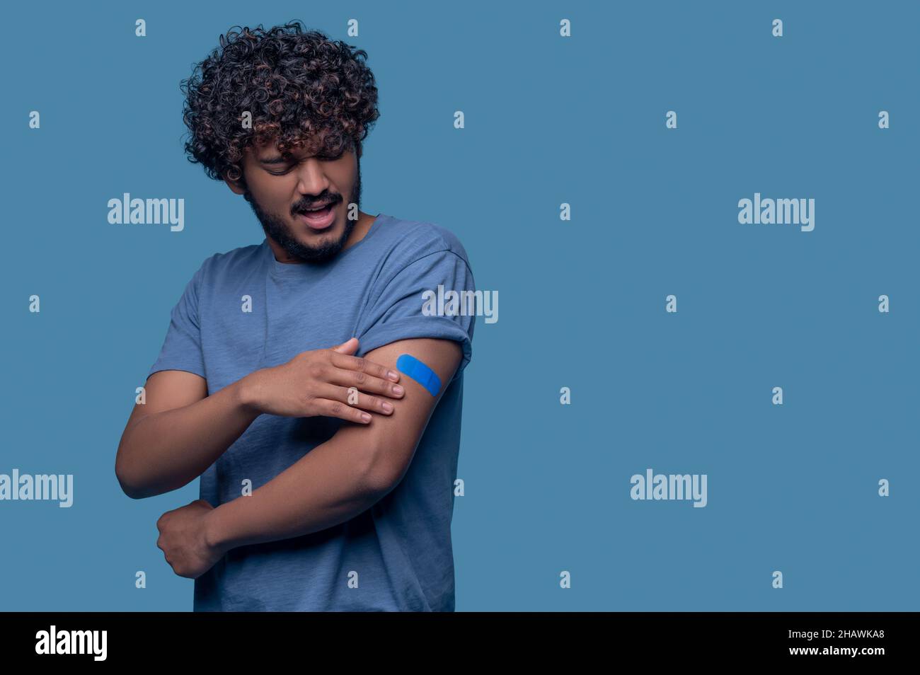 Male patient experiencing arm pain at the injection site Stock Photo ...