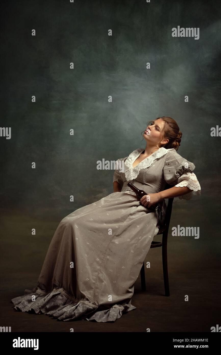 Vintage portrait of young sad girl in gray dress of medieval style ...