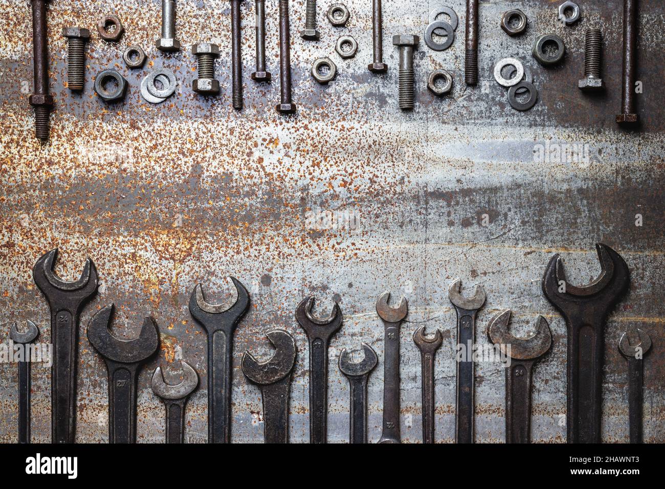 Old work tools and screws on rusty metal table. Top view variation of ...