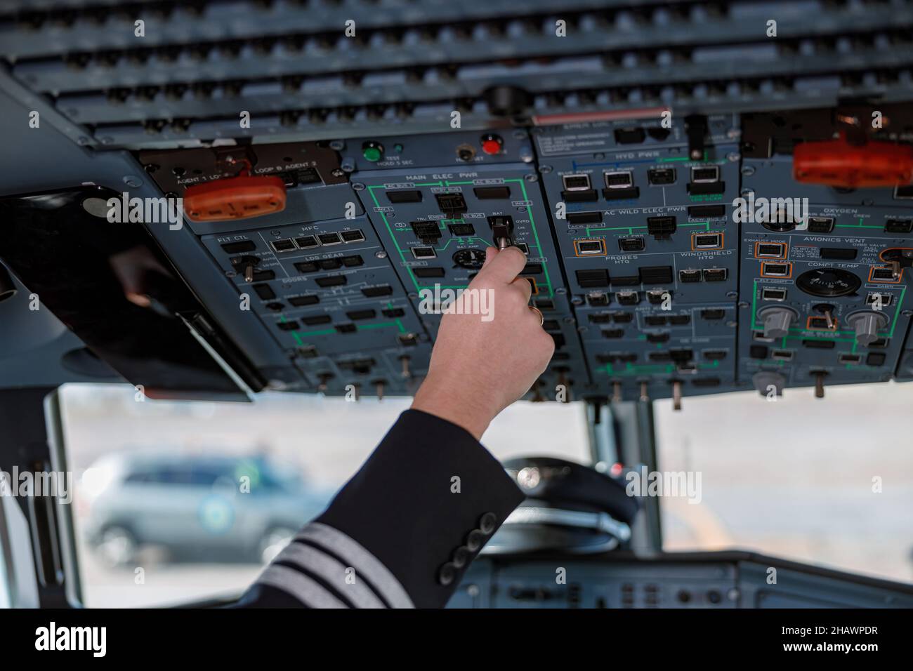 Aircraft pilot operating overhead panel of airplane flight deck Stock ...