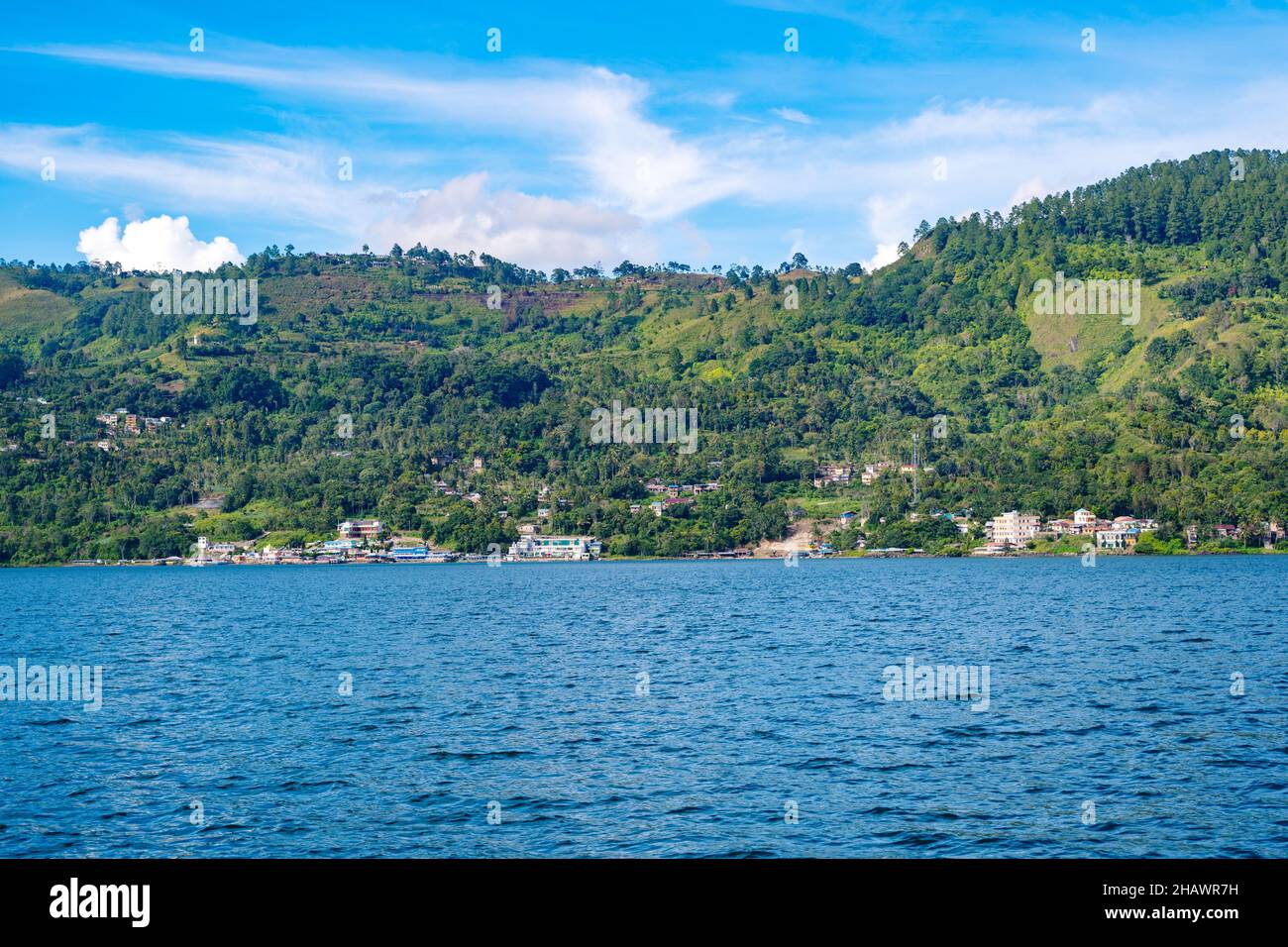 Beautiful landscape of a deep blue lake and its surrounding green hills ...