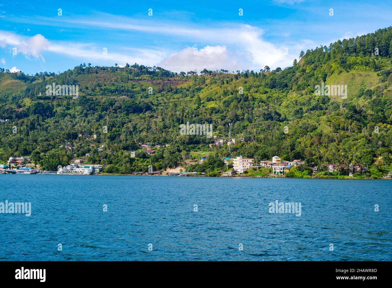 Beautiful landscape of a deep blue lake and its surrounding green hills ...