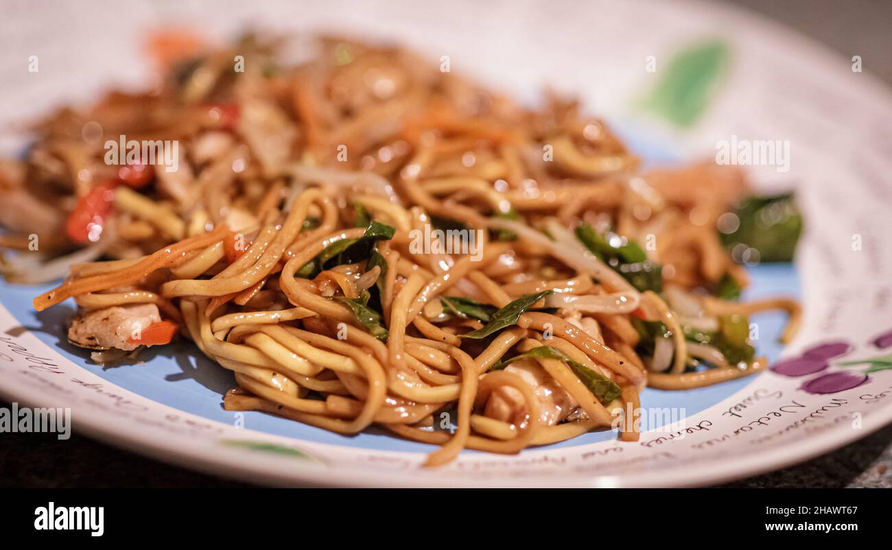A chicken chow mein ready meal cooked and on a plate Stock Photo - Alamy