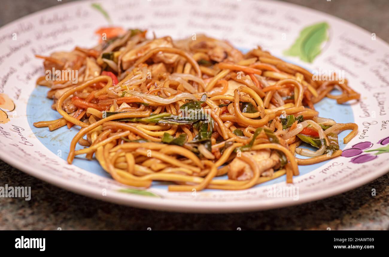 A chicken chow mein ready meal cooked and on a plate Stock Photo - Alamy