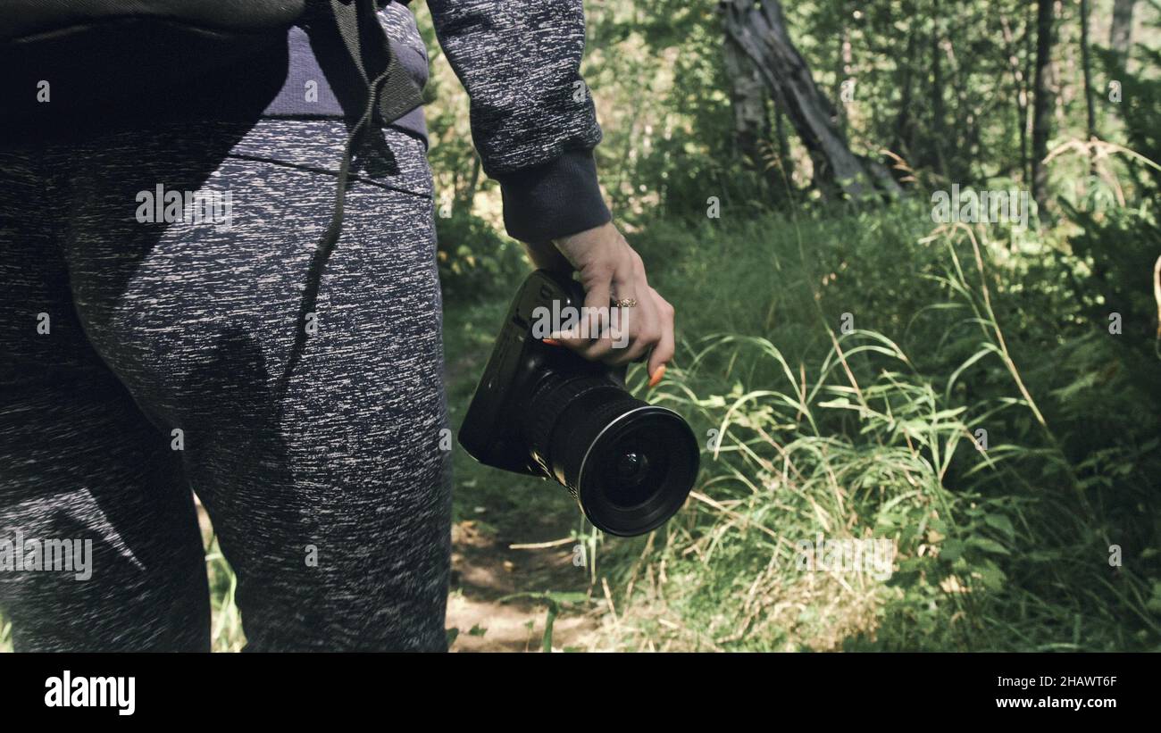 Traveler photographing scenic view in forest. One caucasian woman ...