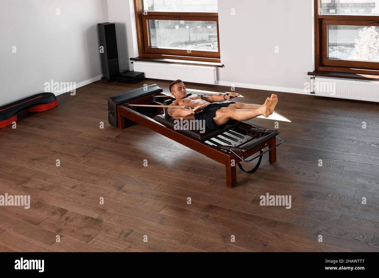 Pilates reformer workout exercises man at gym indoor Stock Photo - Alamy
