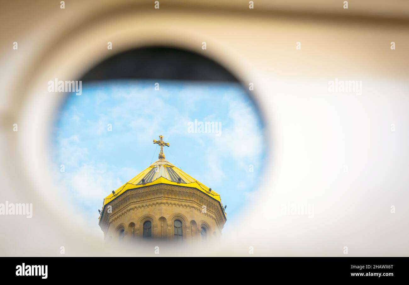 Reflection on viewer eye of Holy trinity cathedral tower with cross on ...