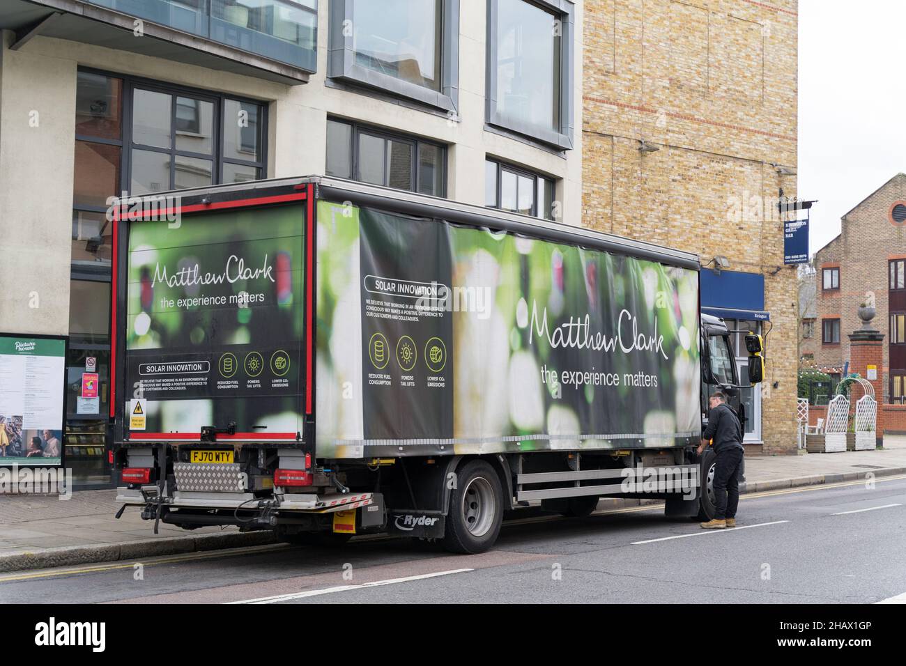 Driver close the canvas side panel at Matthew Clark delivery truck ...