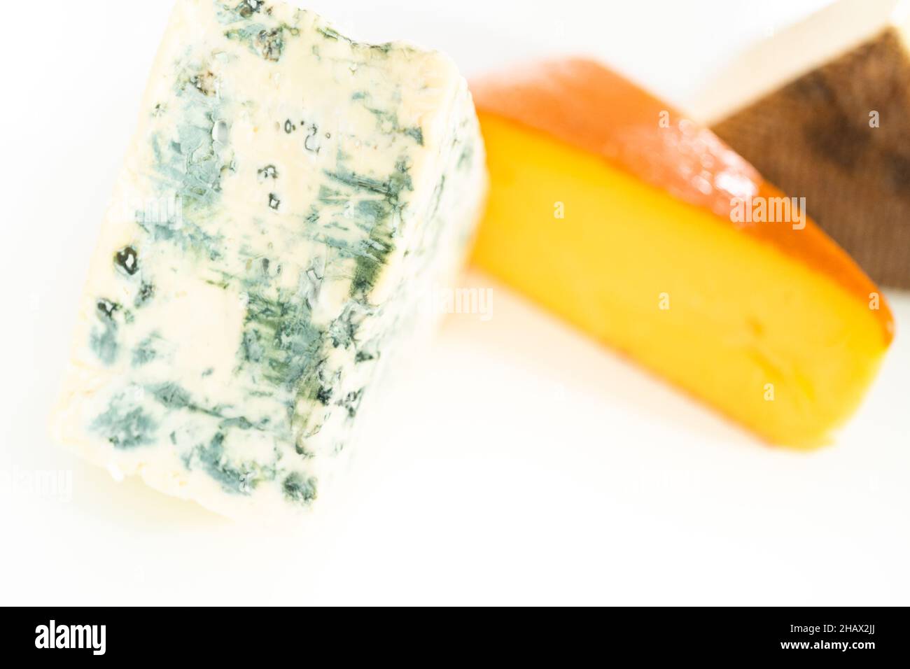 Variety of large wedges gourmet cheese on a white background Stock ...
