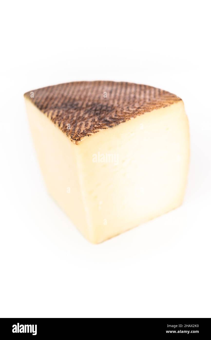Large slice of aged Manchego cheese on a white background Stock Photo - Alamy