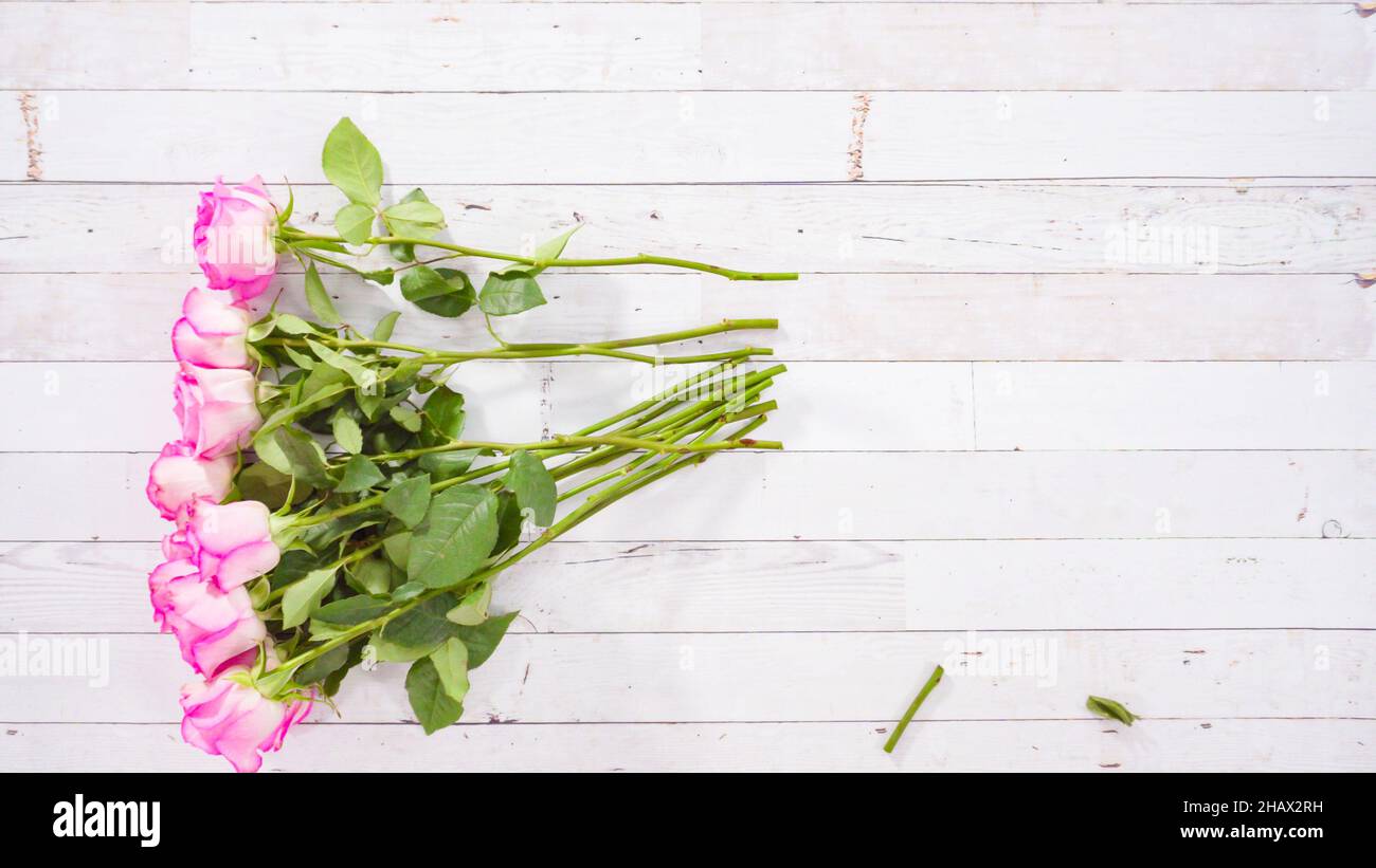 Flat lay. Pruning pink roses for a beautiful bouqet Stock Photo - Alamy