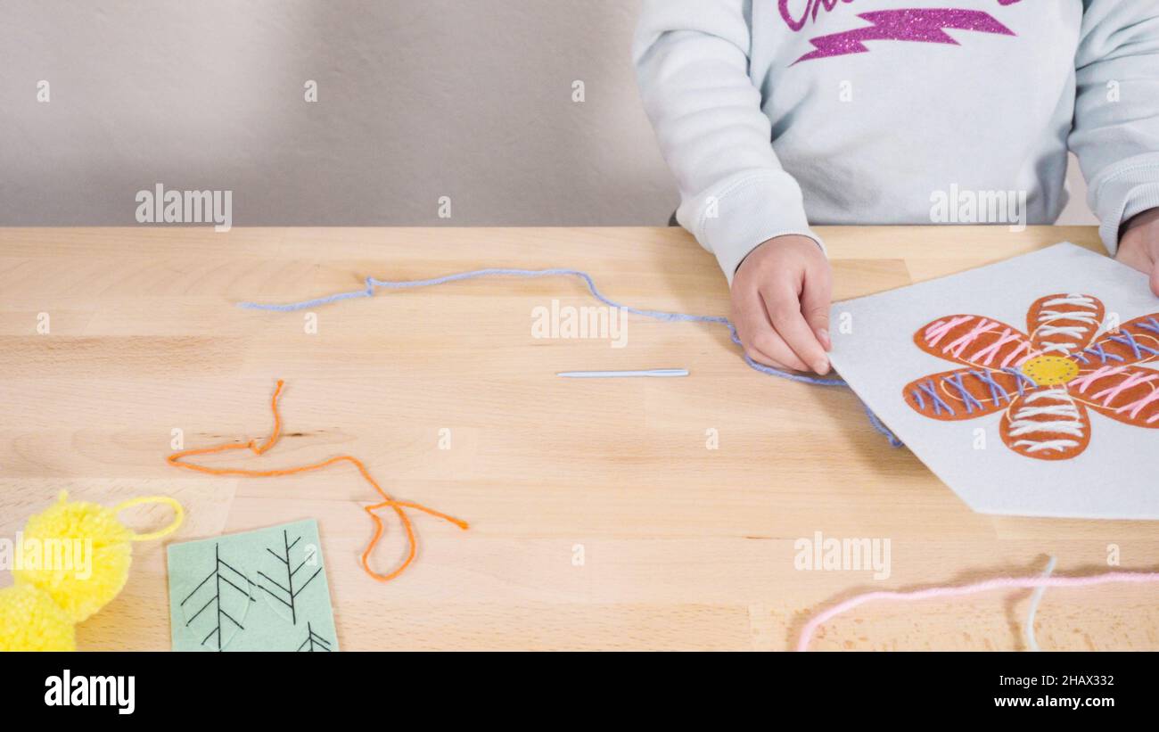 Little girl learning how to sew with sewing craft kit for kids Stock ...