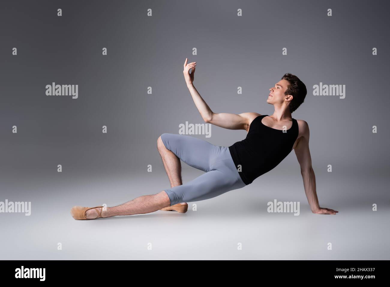 graceful dancer performing ballet dance on dark grey background Stock ...