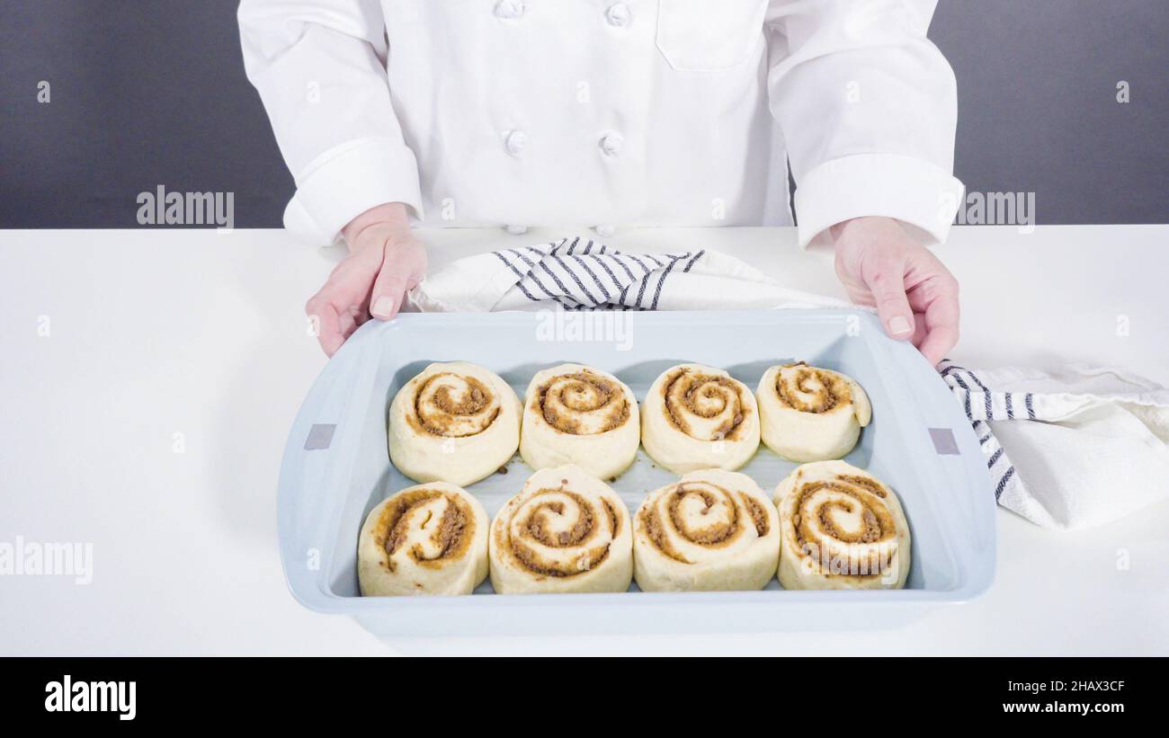 Unbaked cinnamon rolls in a blue baking pan Stock Photo - Alamy