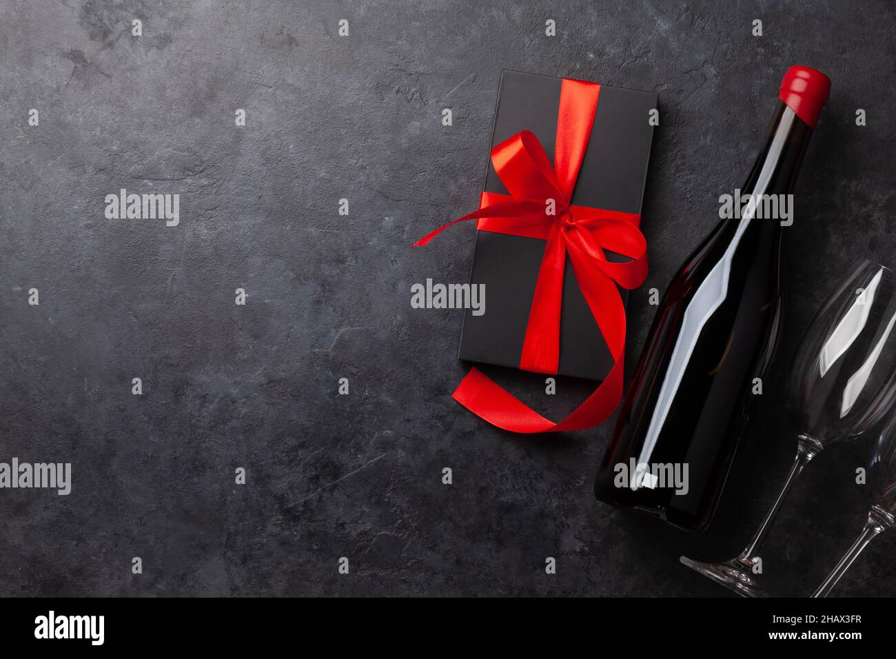 Valentines day gift box and red wine bottle. Top view flat lay. With ...