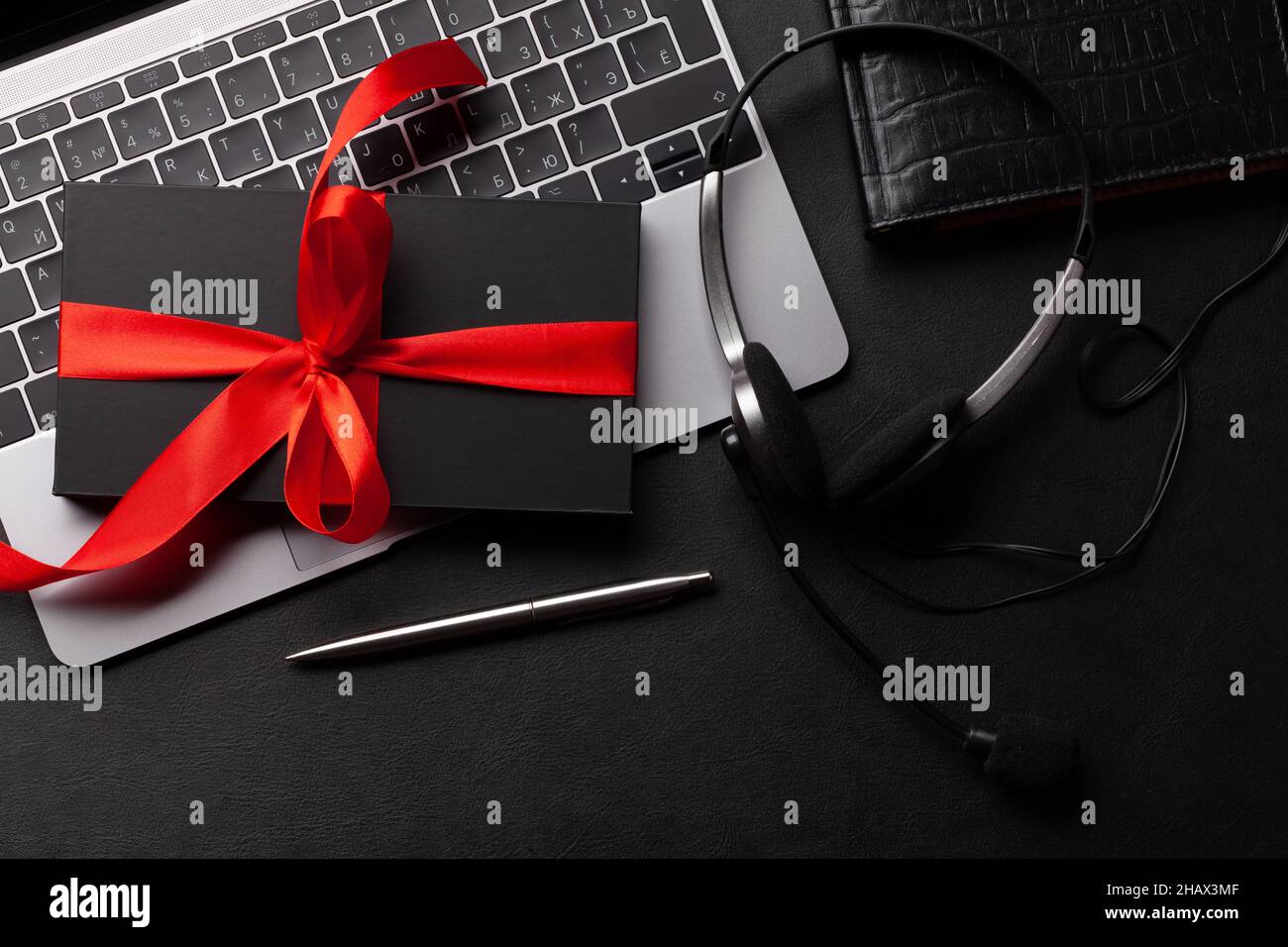 Gift box over laptop on office desk table. Top view flat lay with copy ...
