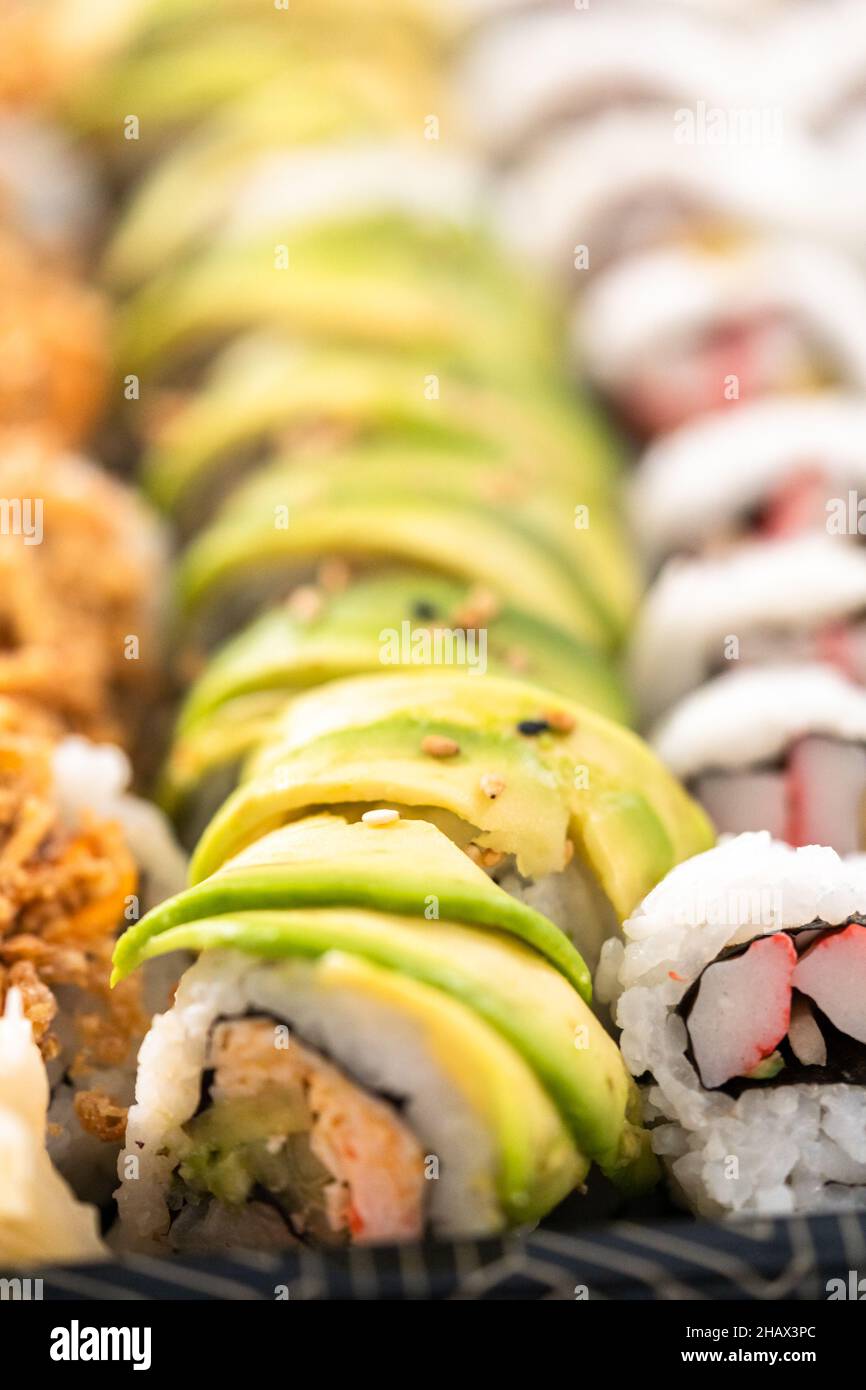 Pre-packaged variety of sushi and sushi rolls in a plastic tray Stock ...