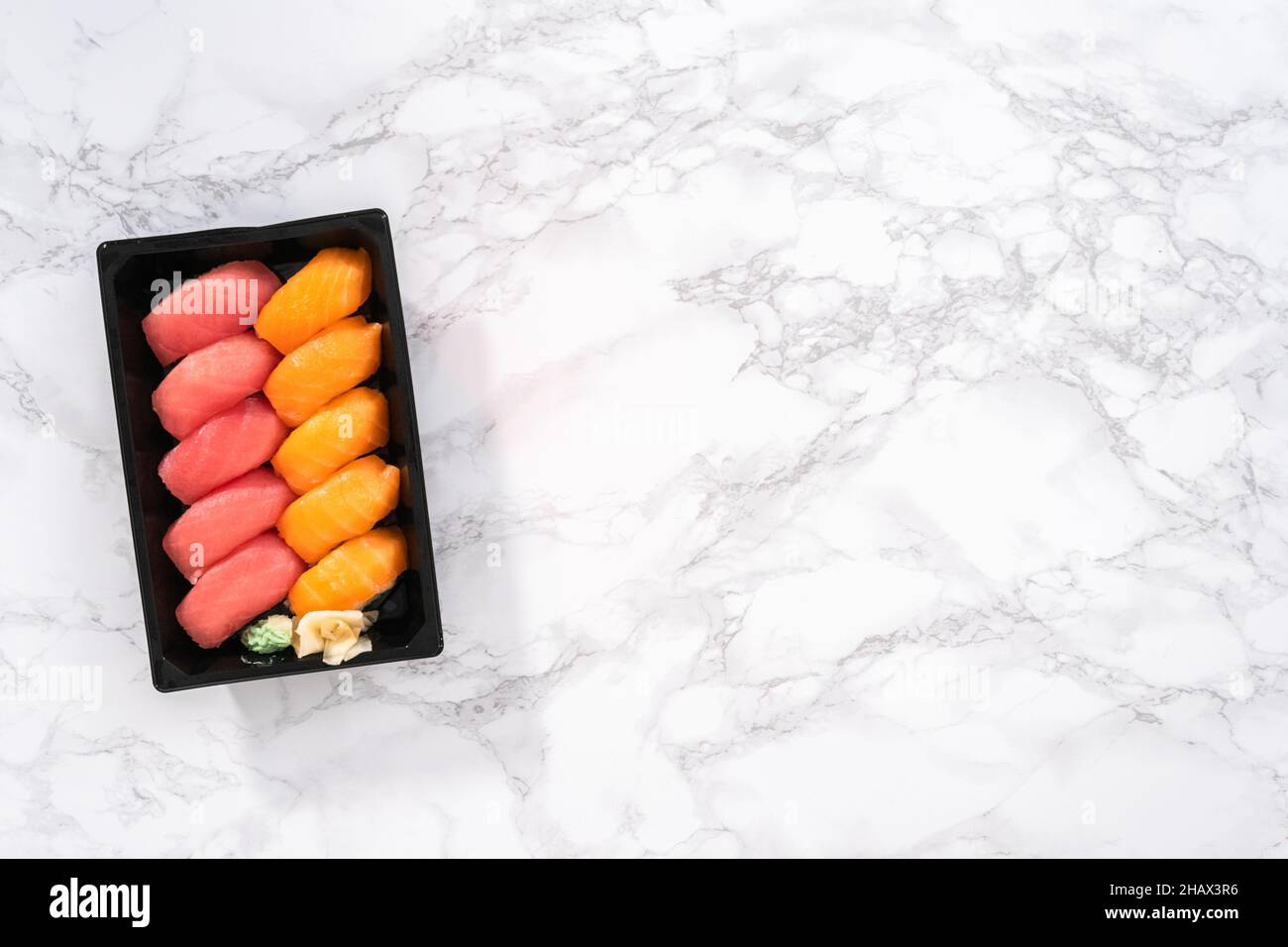 Flat lay. Pre-packaged sushi in a plastic tray Stock Photo - Alamy