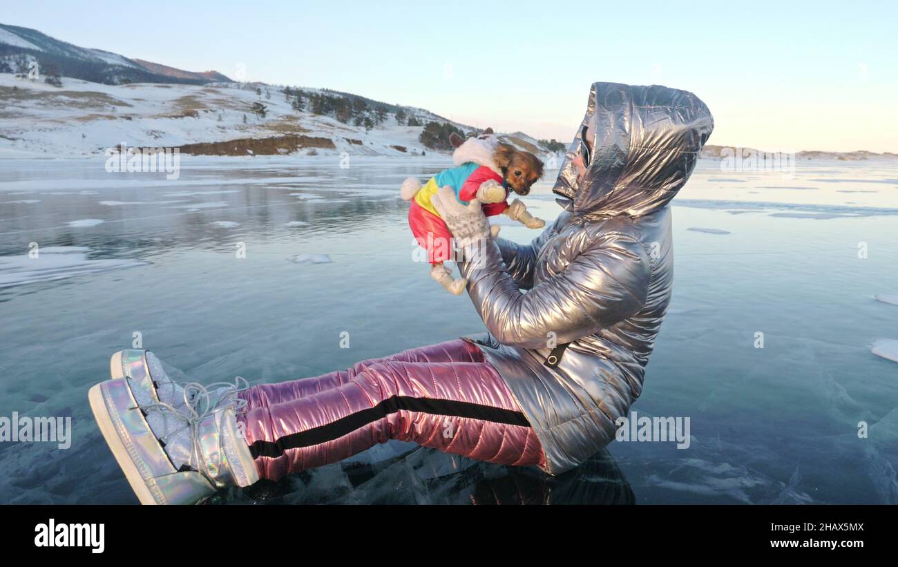 Toy Terrier in funny clothes and funny shoes plays with ball on ...