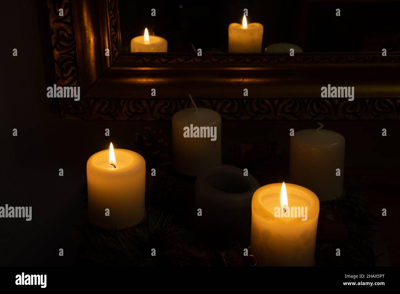 Burning candles in the dark reflected in a mirror Stock Photo - Alamy