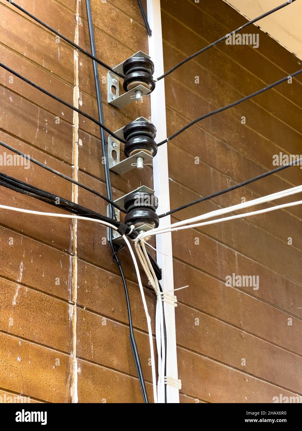 The spool Insulators in the electric wire system on the building wall ...