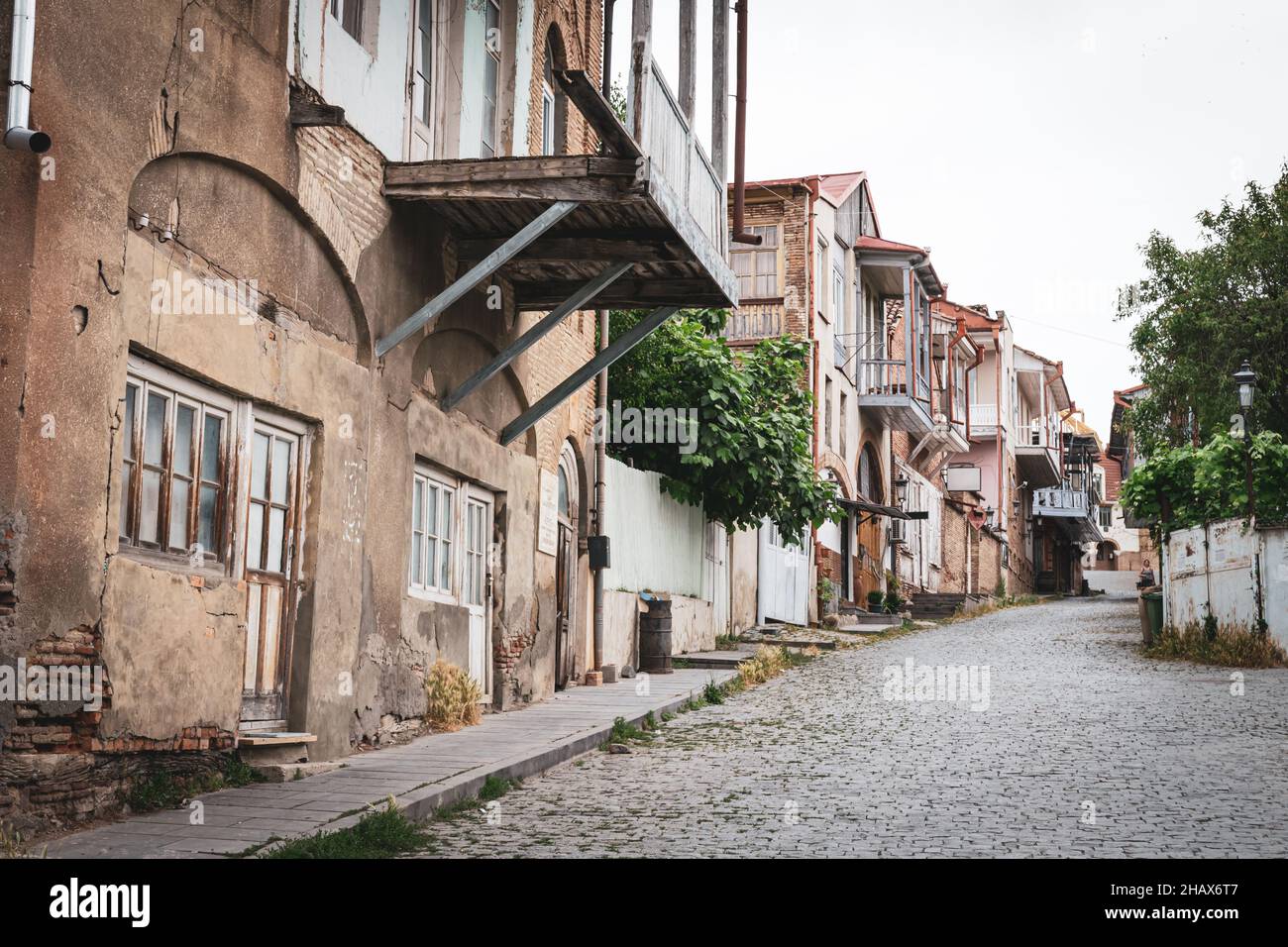 Old wooden balcony and historical connected georgian houses with street ...