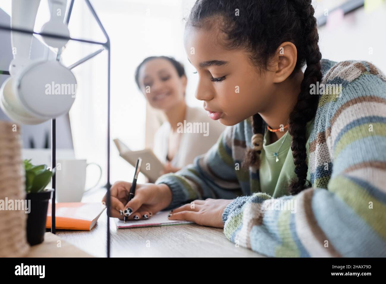 African american teen writing hi-res stock photography and images - Alamy