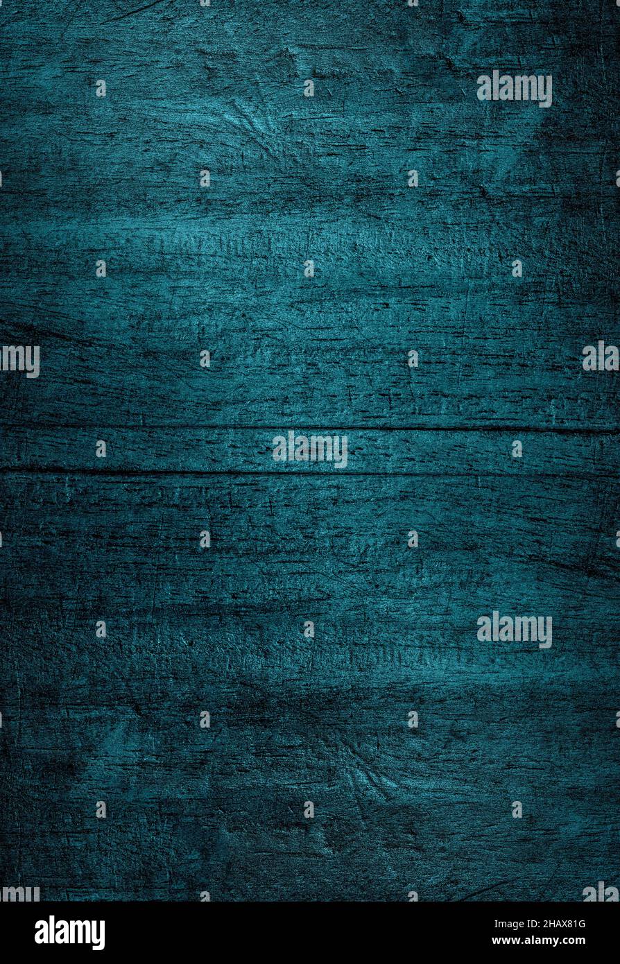 A dark cyan color wooden plank with scratches texture for background ...