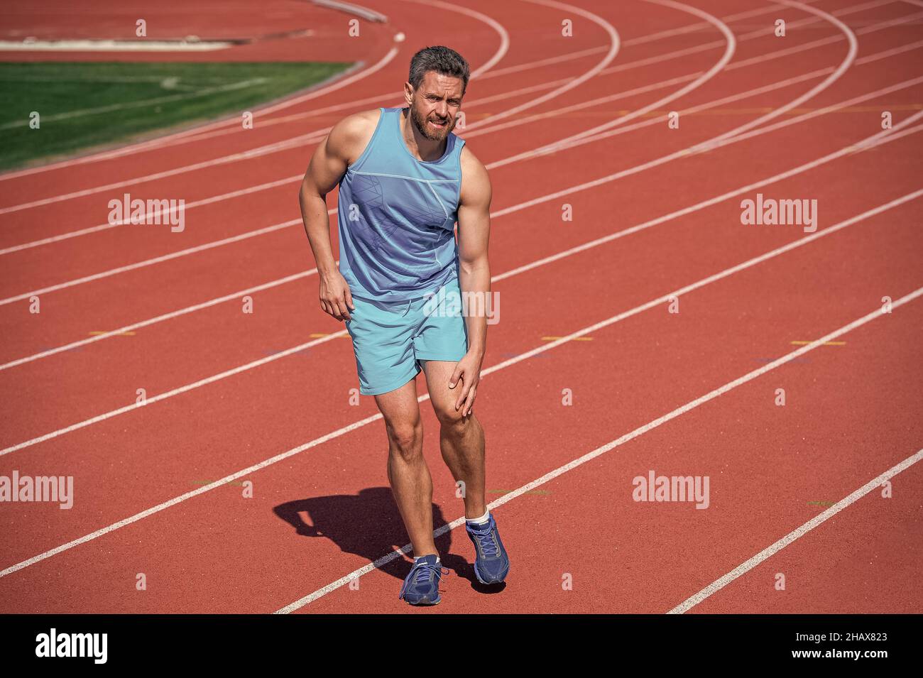 hurts too much. male trauma. sportsman athlete flex muscles and knead a ...