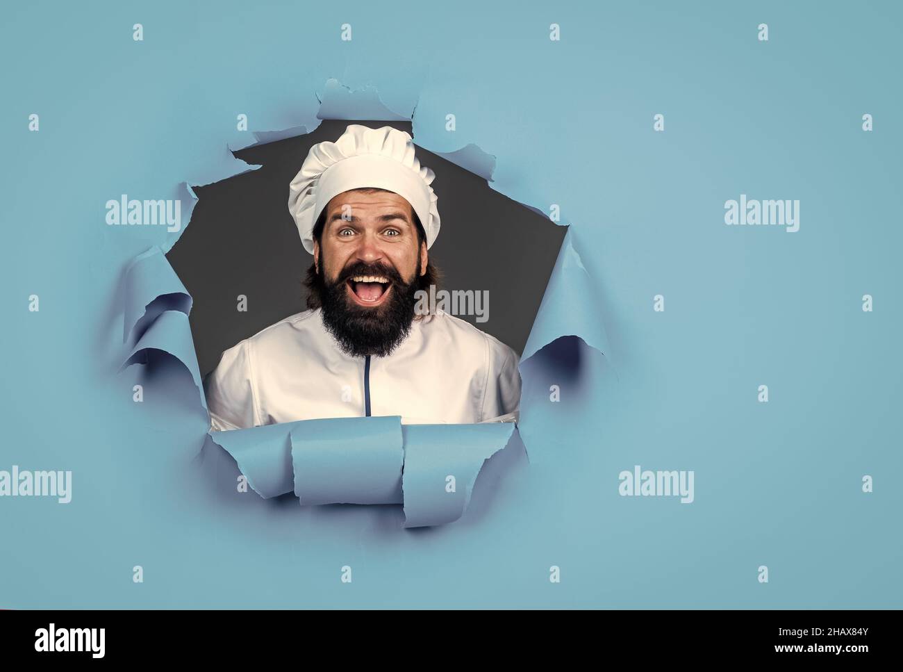 happy professional restaurant bearded cook guy on blue background, copy ...