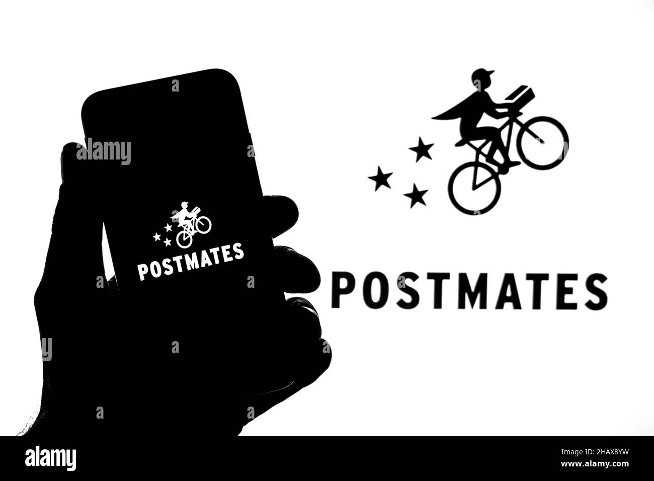 In this photo illustration a Postmates logo seen displayed on a ...