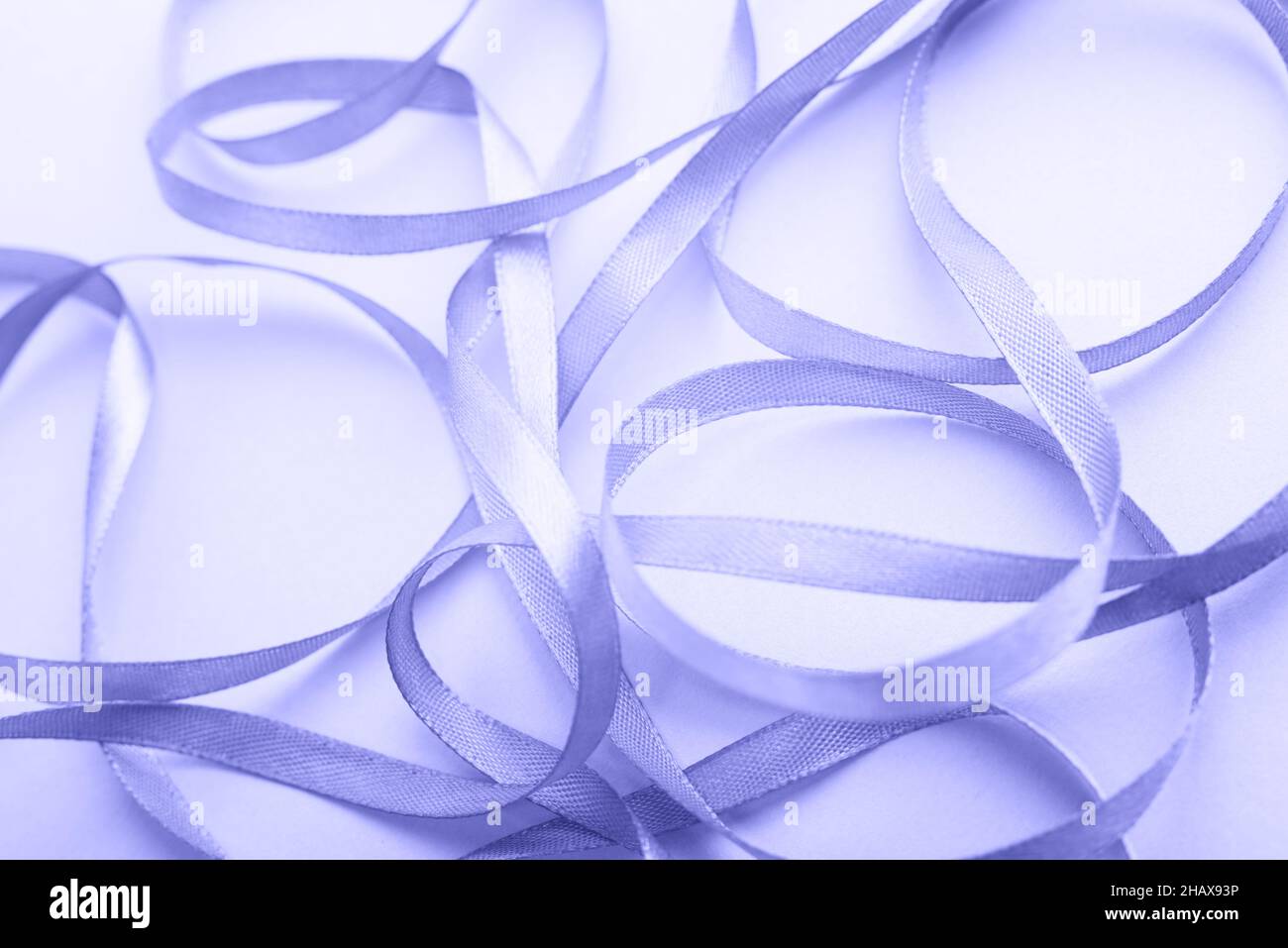 Curved purple gold silk ribbon on purple background. Closeup Stock ...