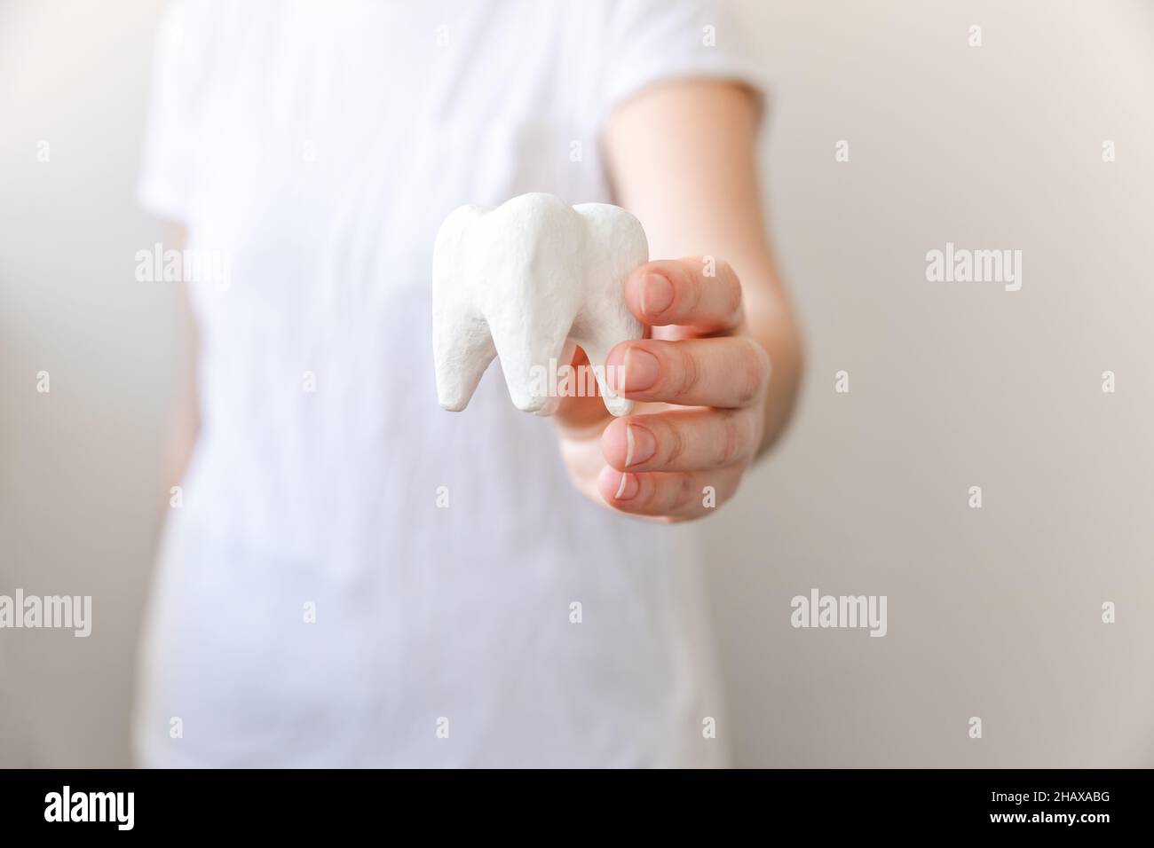 Health dental care concept. Woman hand holding white healthy tooth ...