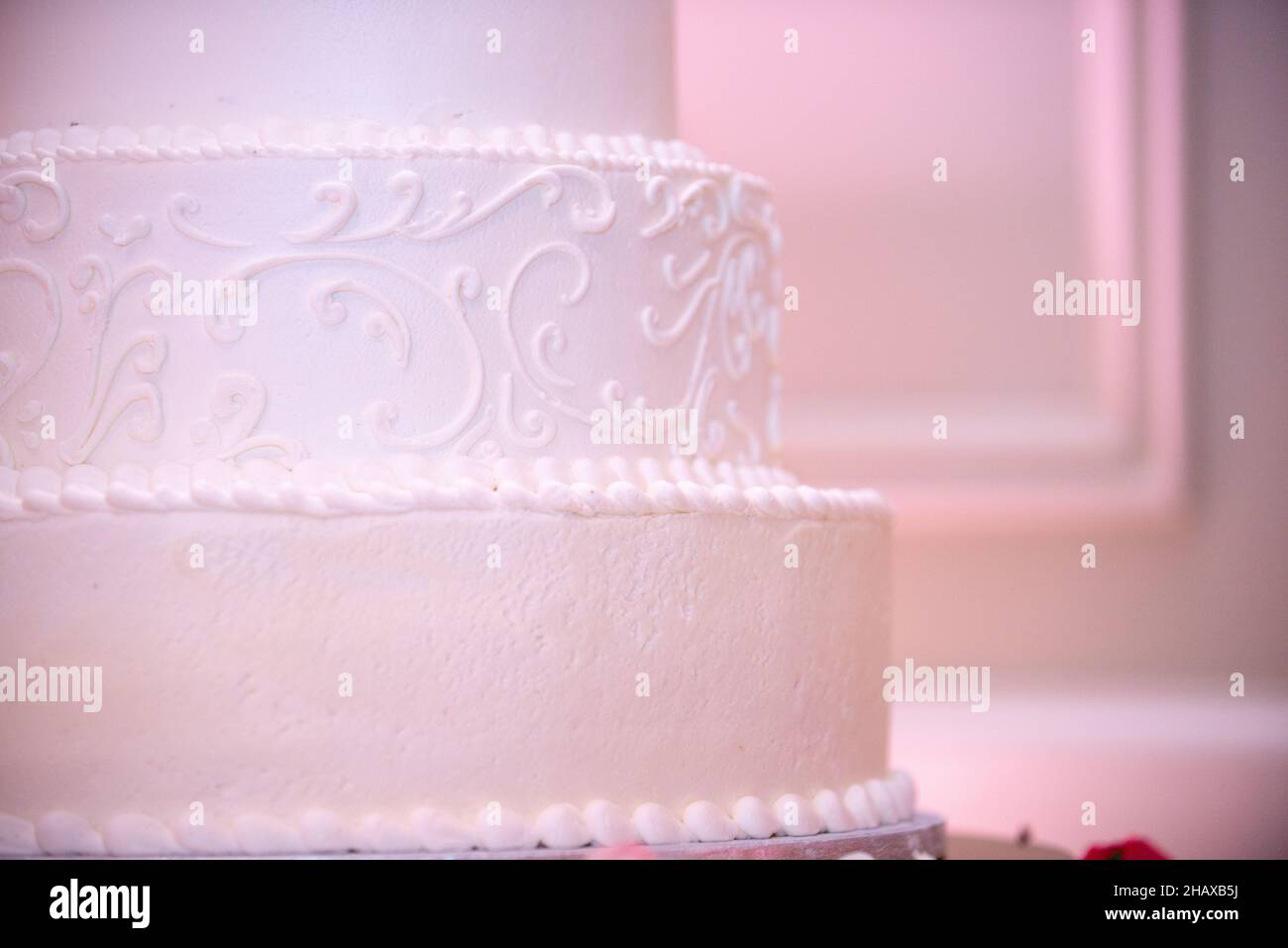 Close up white three tier cake with ornate design Stock Photo - Alamy