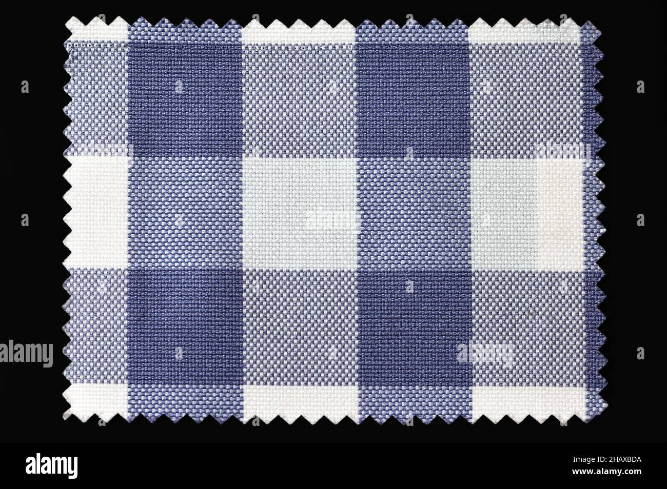 Blue and white checkered fabric sample isolated on black background ...
